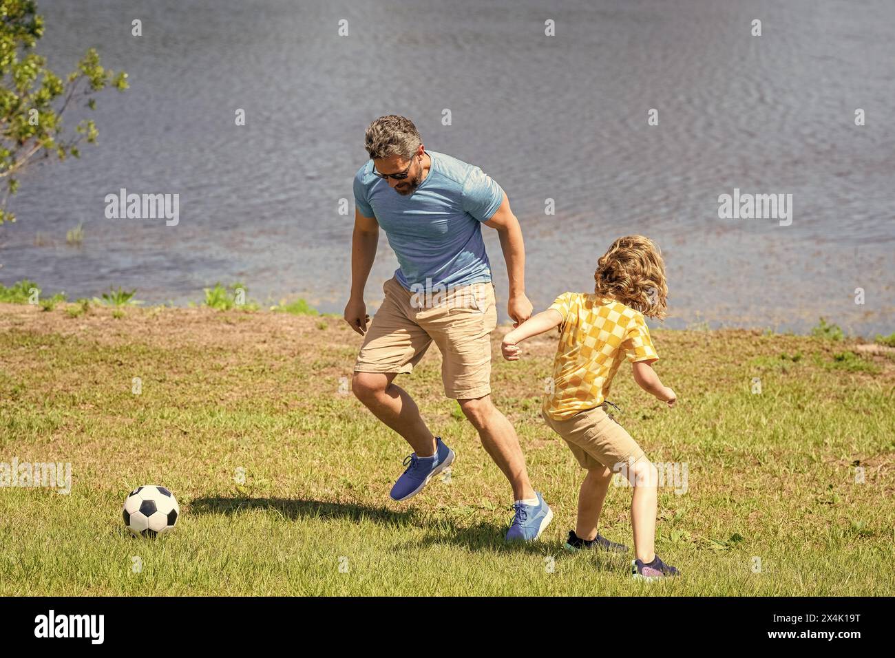 dad and son playing football during their childhood. Childhood memories ...
