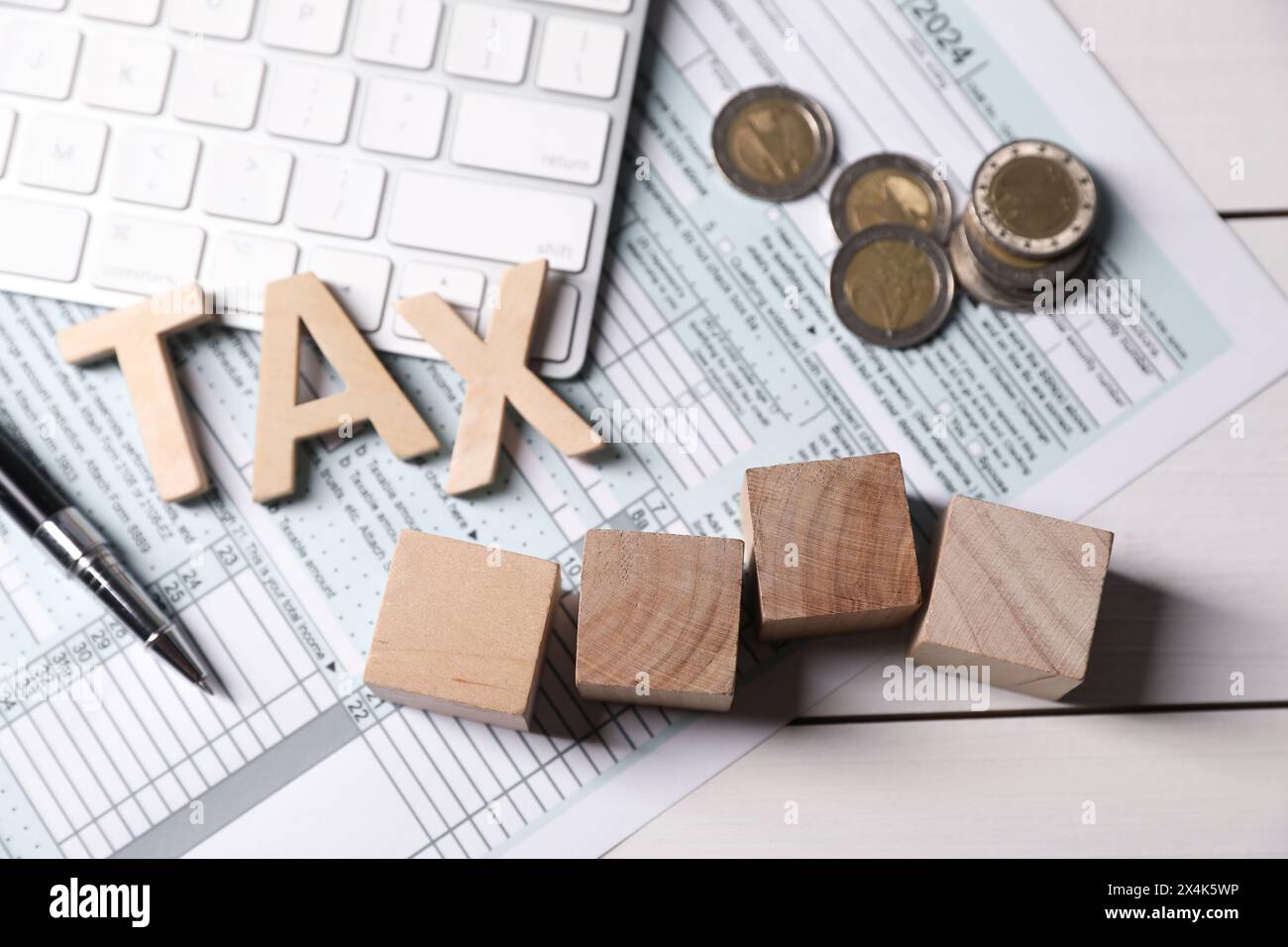 Tax accounting. Cubes with numbers 2024, document, keyboard, coins and ...