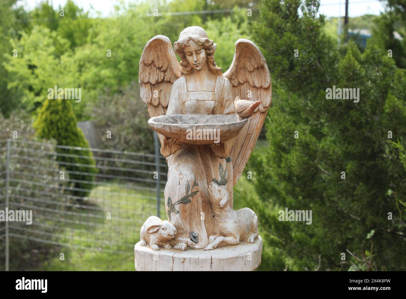 Concrete Angel Bird Feeder Stock Photo - Alamy