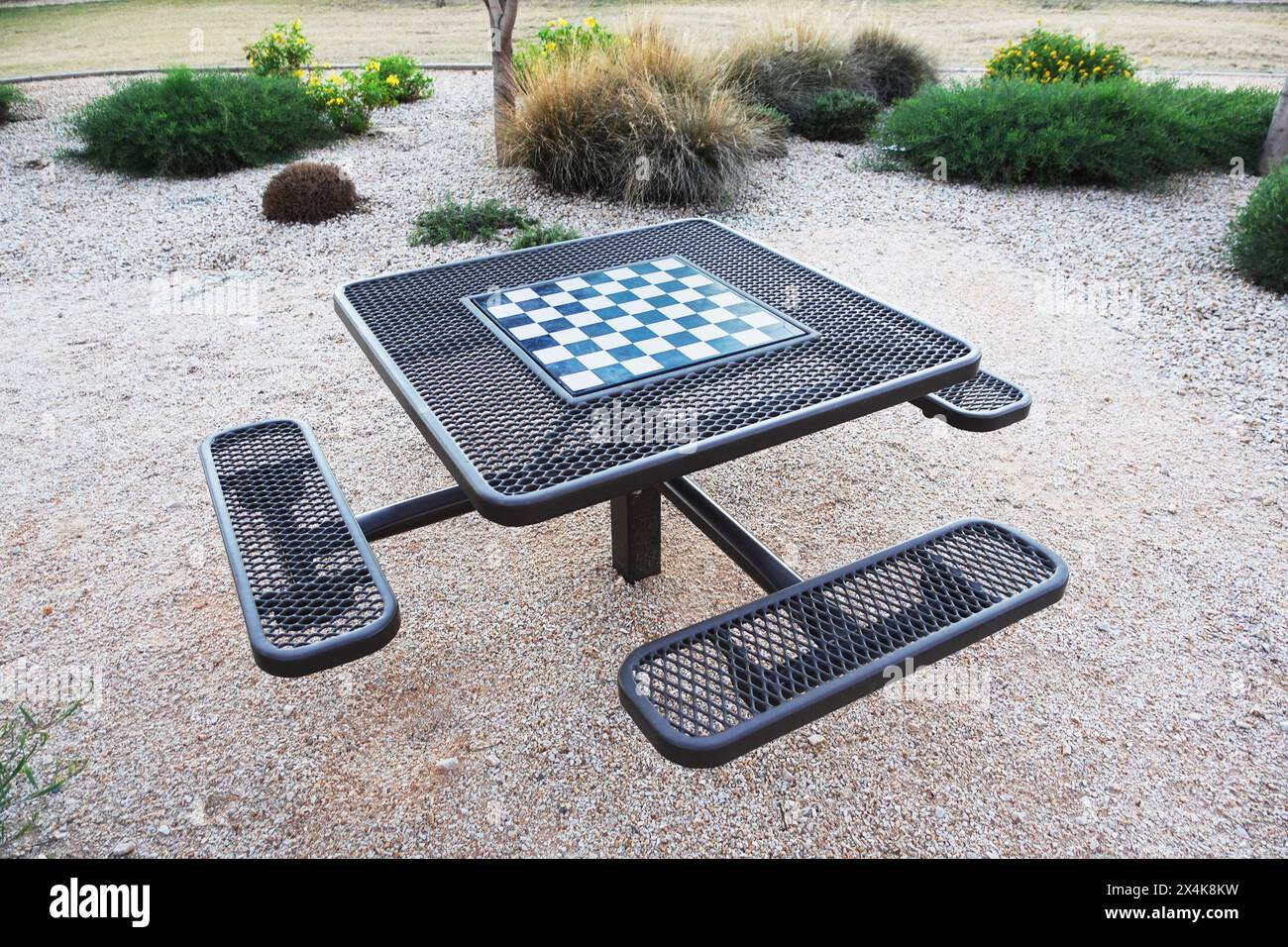 Metal mesh chess table with seats in a public park Stock Photo - Alamy