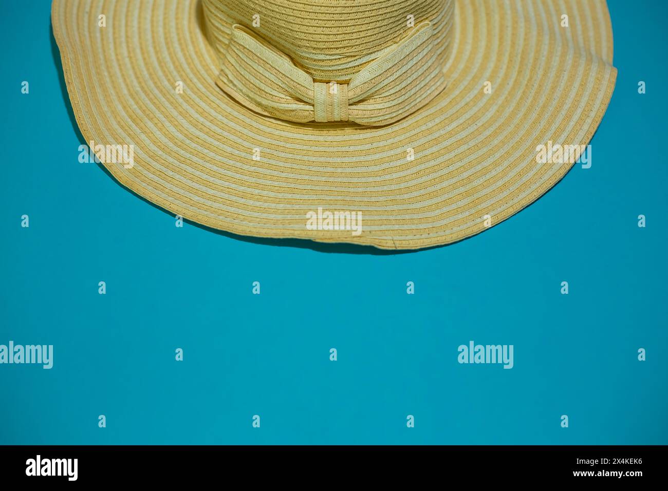 Womens summer yellow straw hat on a blue background. Summer concept ...
