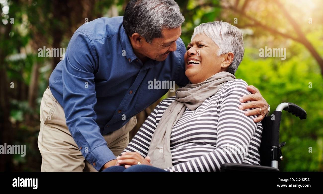 Senior couple, hug and wheelchair in nature by trees with love ...