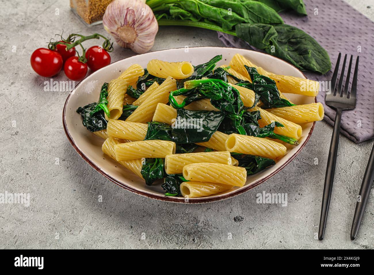 Italian cuisine - pasta tortiglioni with spinach Stock Photo - Alamy