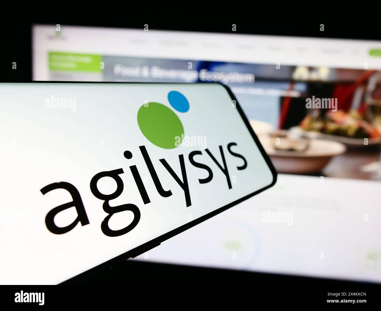 Smartphone with logo of American enterprise software company Agilysys Inc. in front of business ...