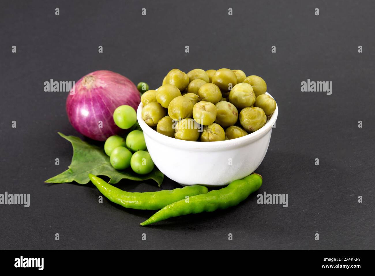 Boiled tiny Wild Eggplant eggplant on white bolw with onion and chili ...