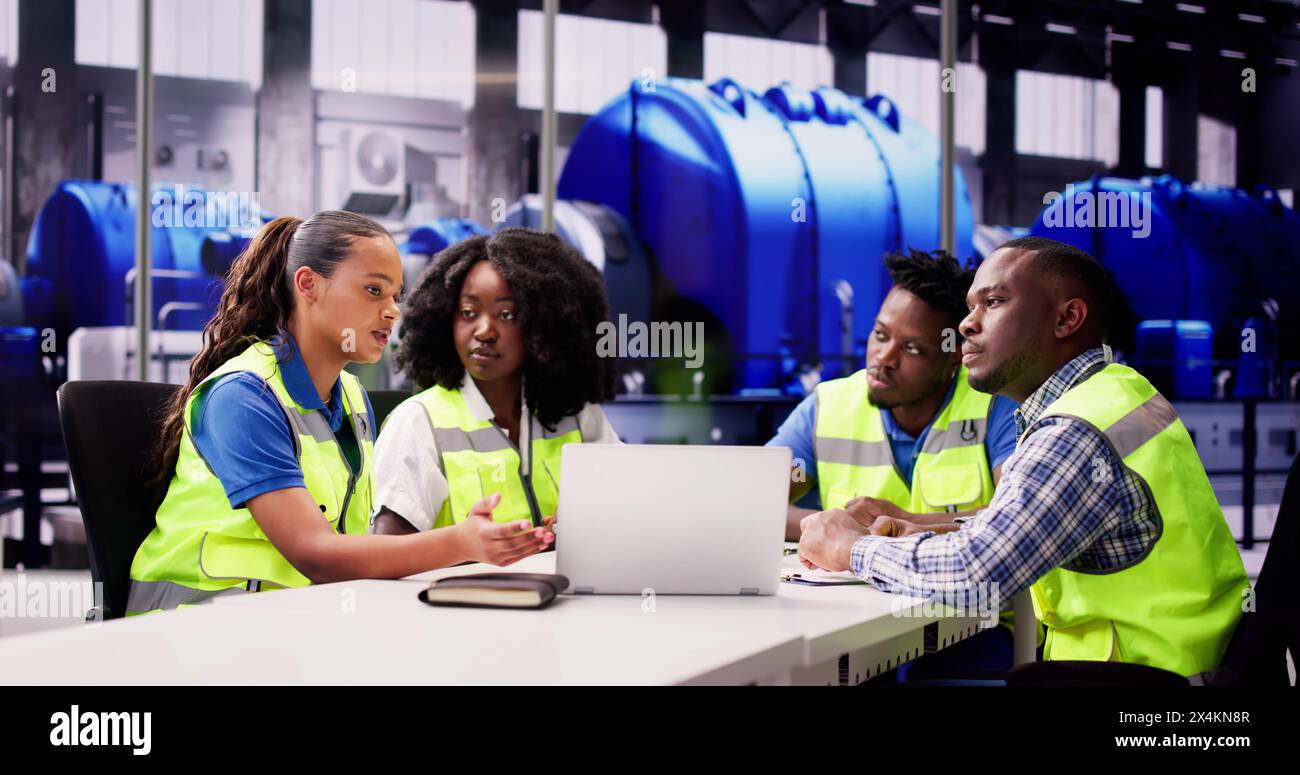 Team Of Engineers Talking At Industrial Workplace Stock Photo - Alamy