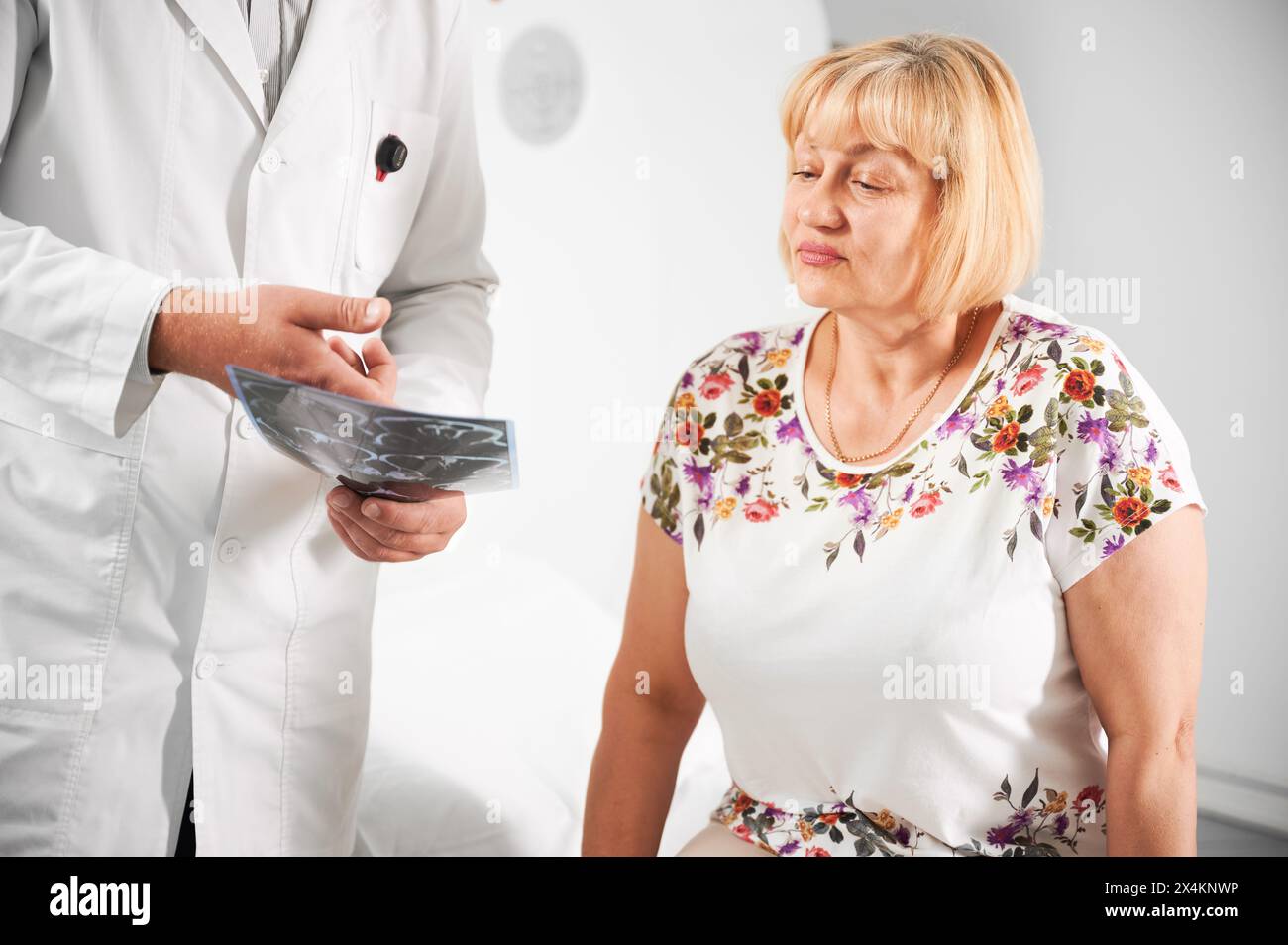 Patient making MRI, doctor holding and explaining results. Woman ...