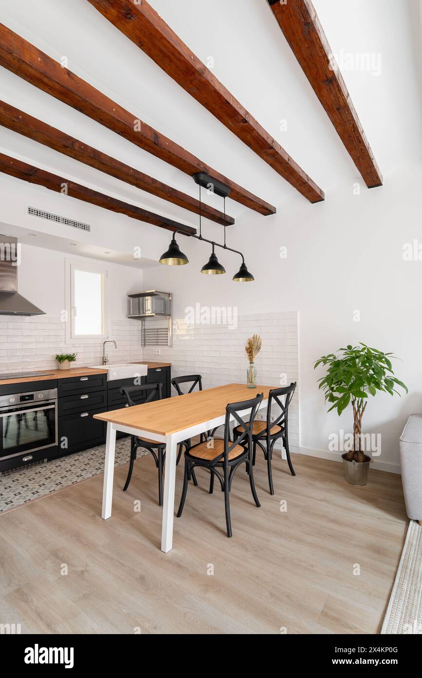 Dining table with wooden surface and chairs in kitchen Stock Photo - Alamy