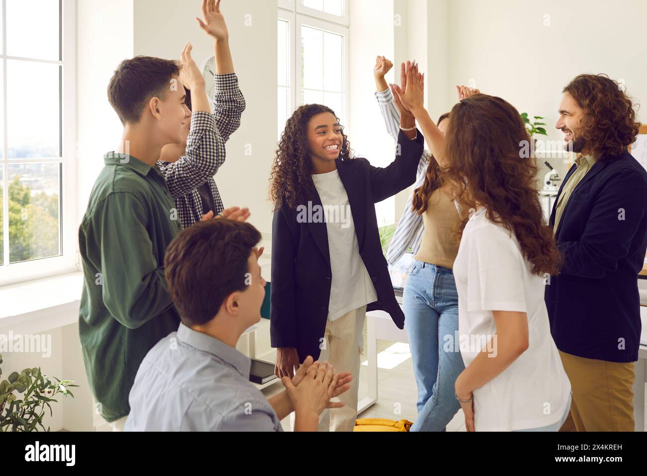 Group of happy diverse teenage students together with teacher having ...