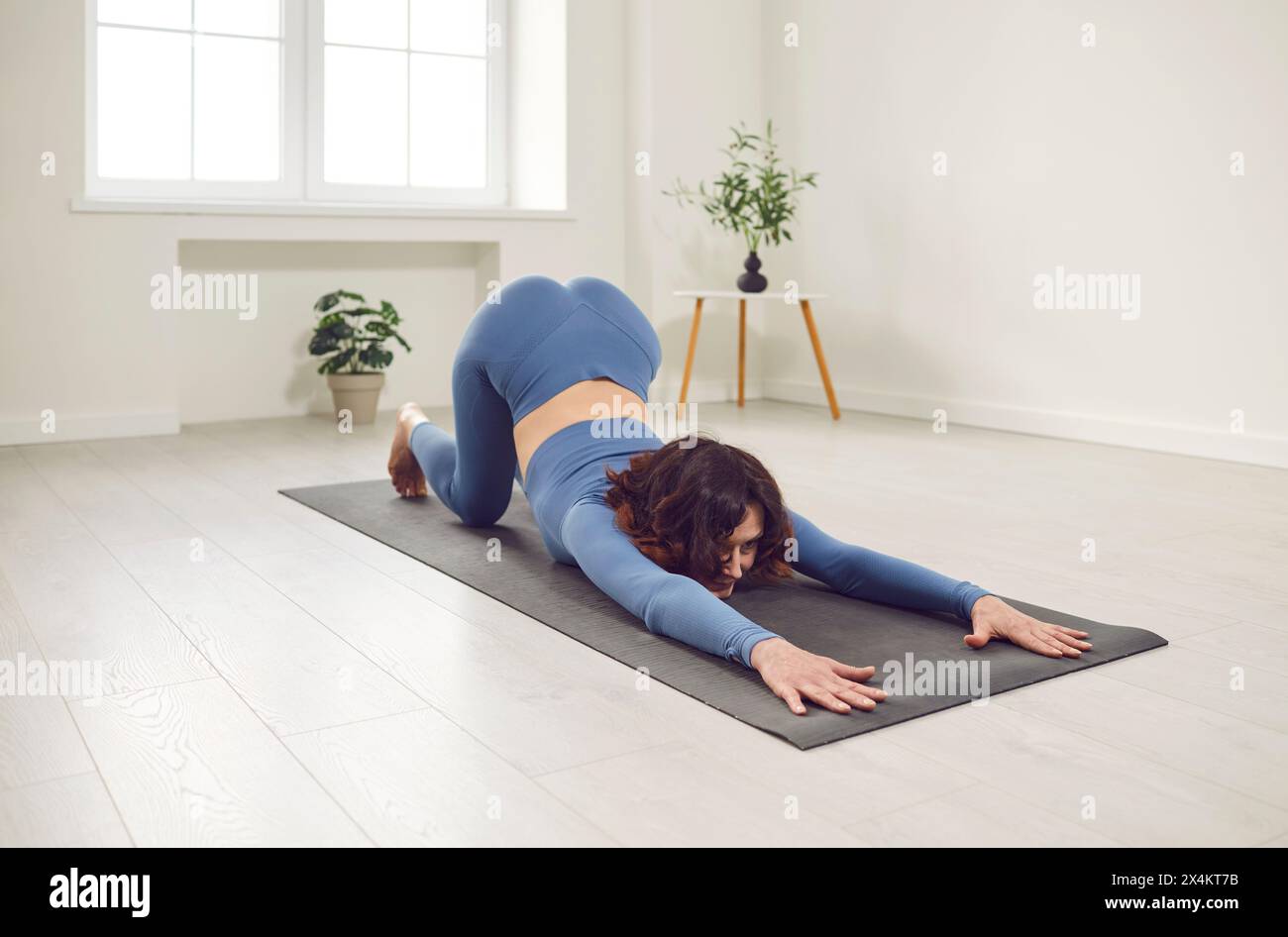 Beautiful sporty girl practices backbend yoga posture doing exercise ...