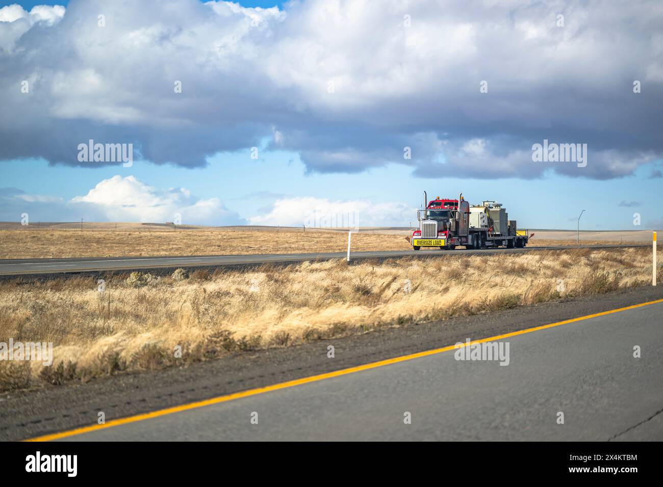 Red carrier big rig semi truck with extended cab and oversize load sign ...