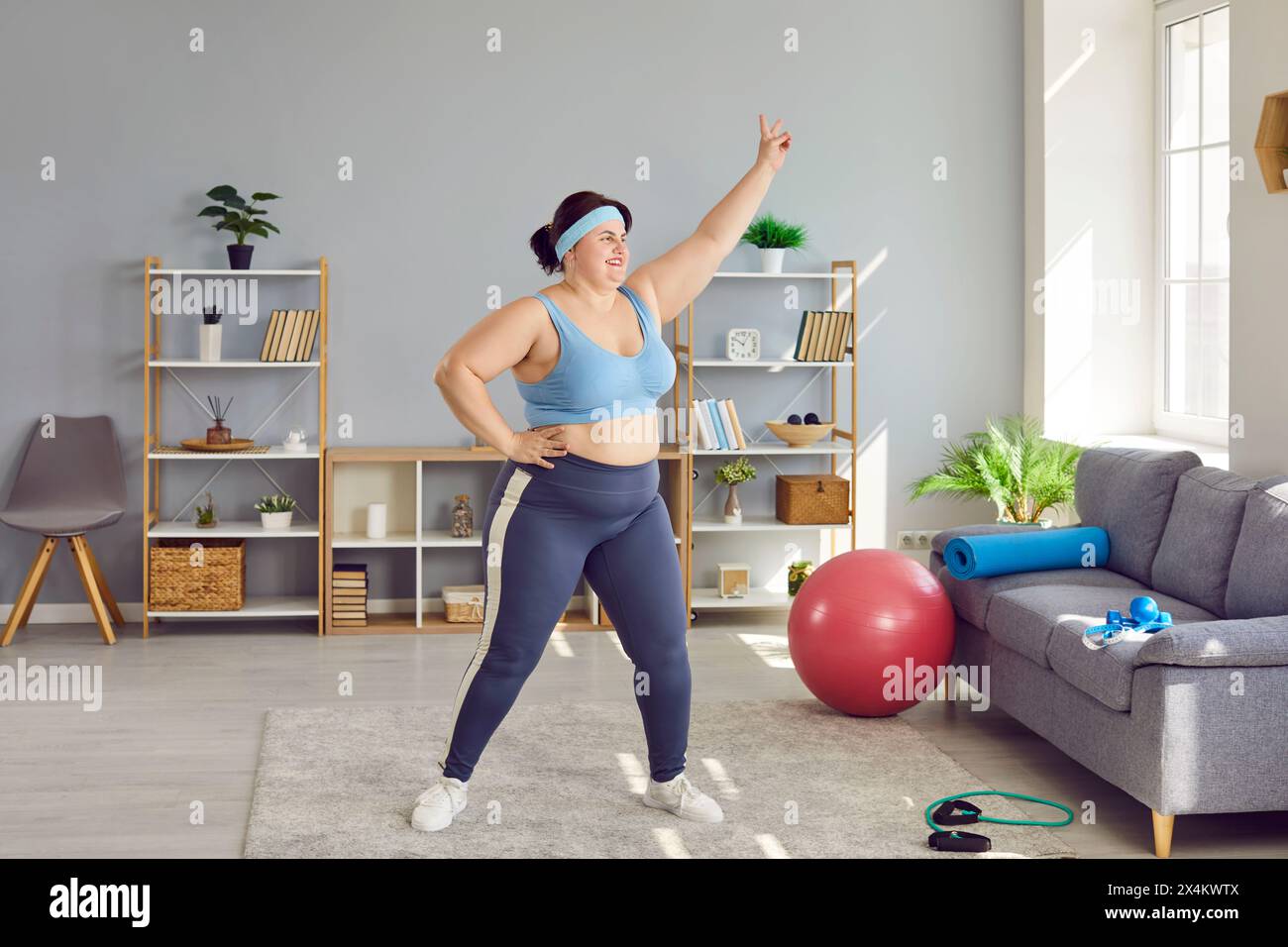 Overweight, obese woman doing physical exercises indoors at home Stock ...