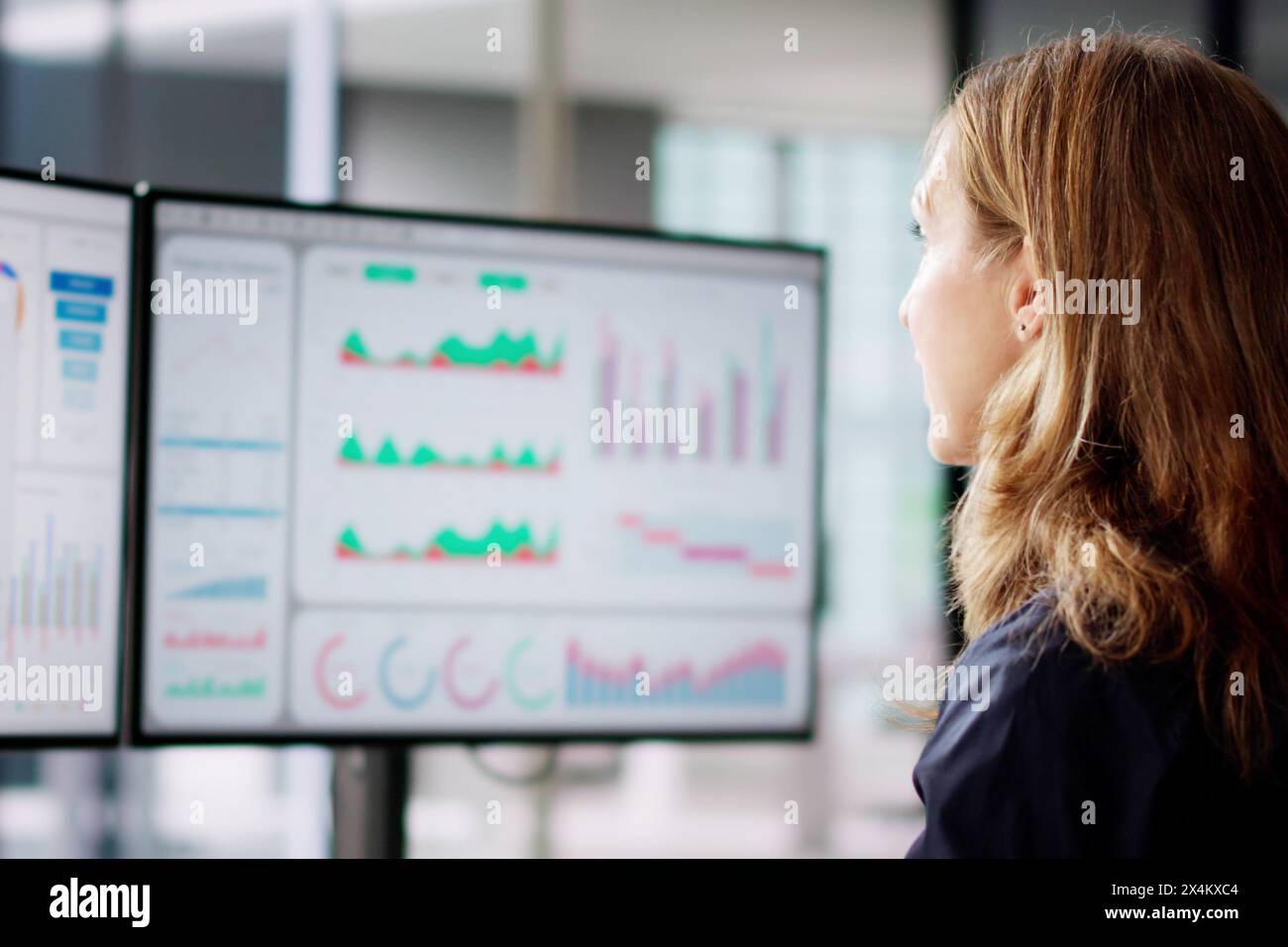 Unhappy woman looking overwhelmed at computer dashboard in business ...