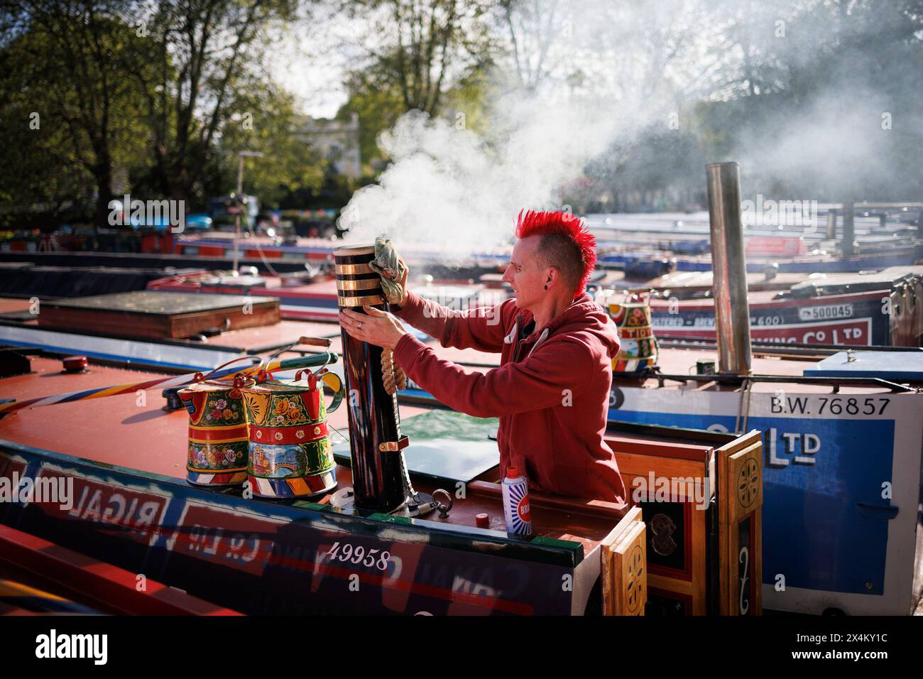 London, UK. 04th May, 2024. A narrowboat owner polishes brass on this ...