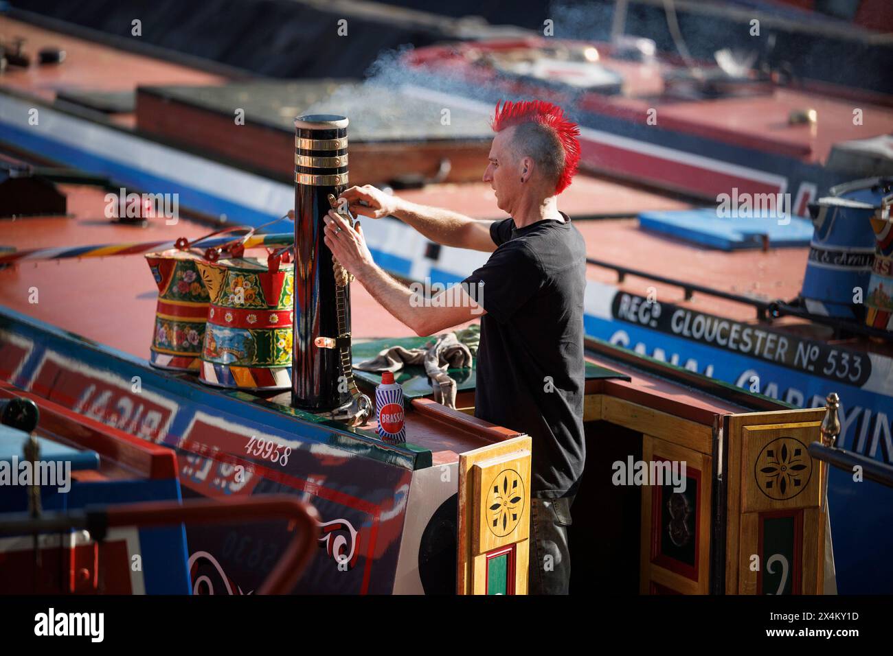 London, UK. 04th May, 2024. A narrowboat owner polishes brass on this ...