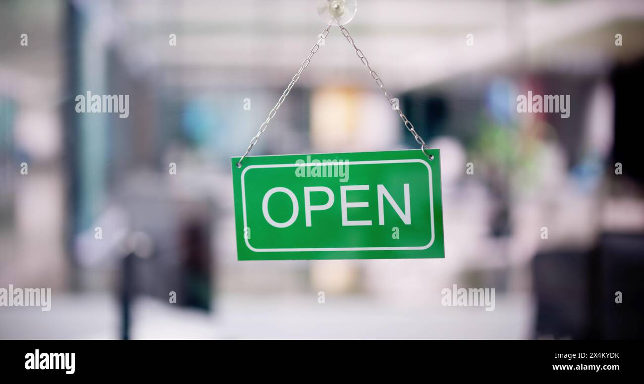 Male Owner Holding Open Sign In His Store Stock Photo - Alamy