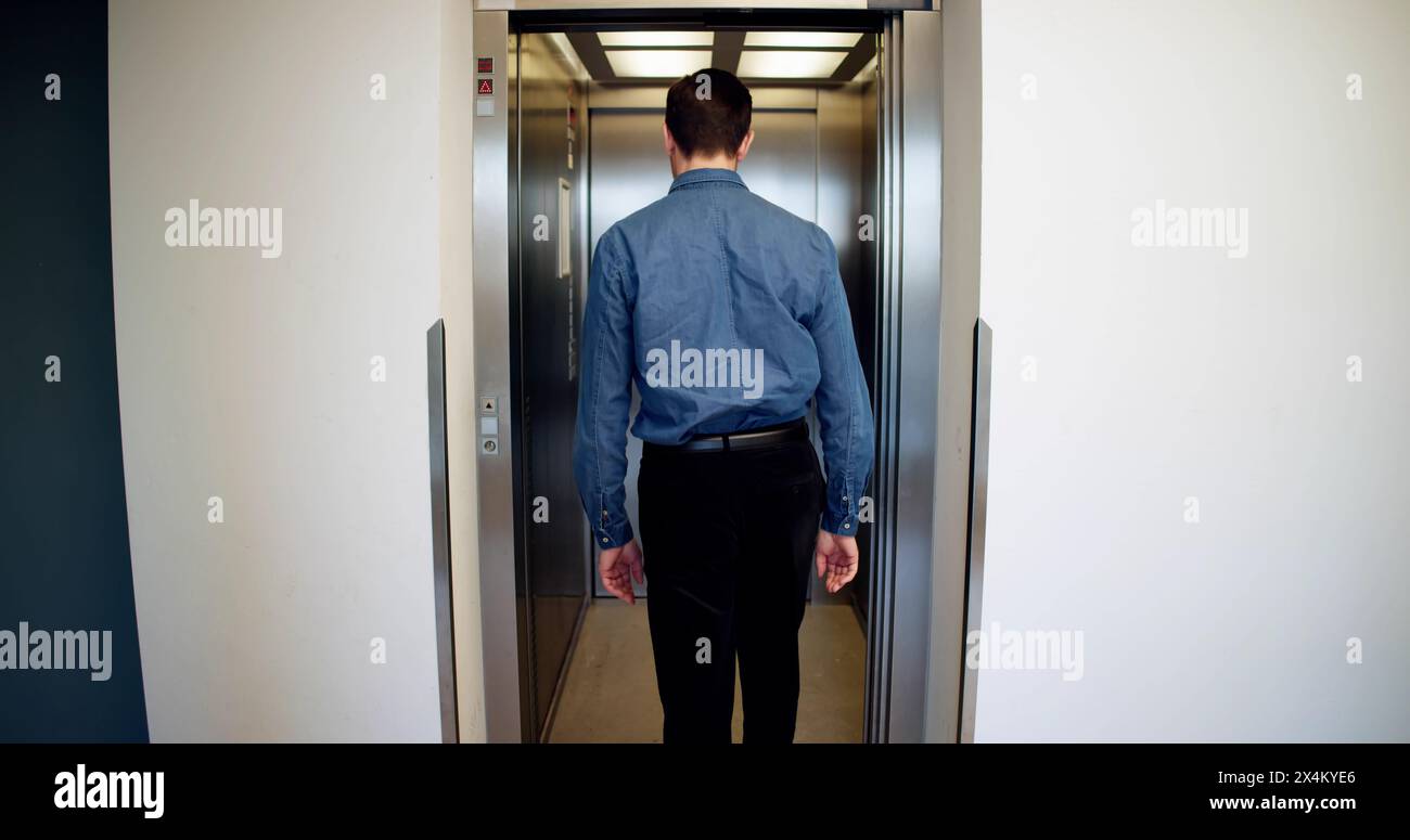 Rear View Of A Man Using Elevator Stock Photo - Alamy