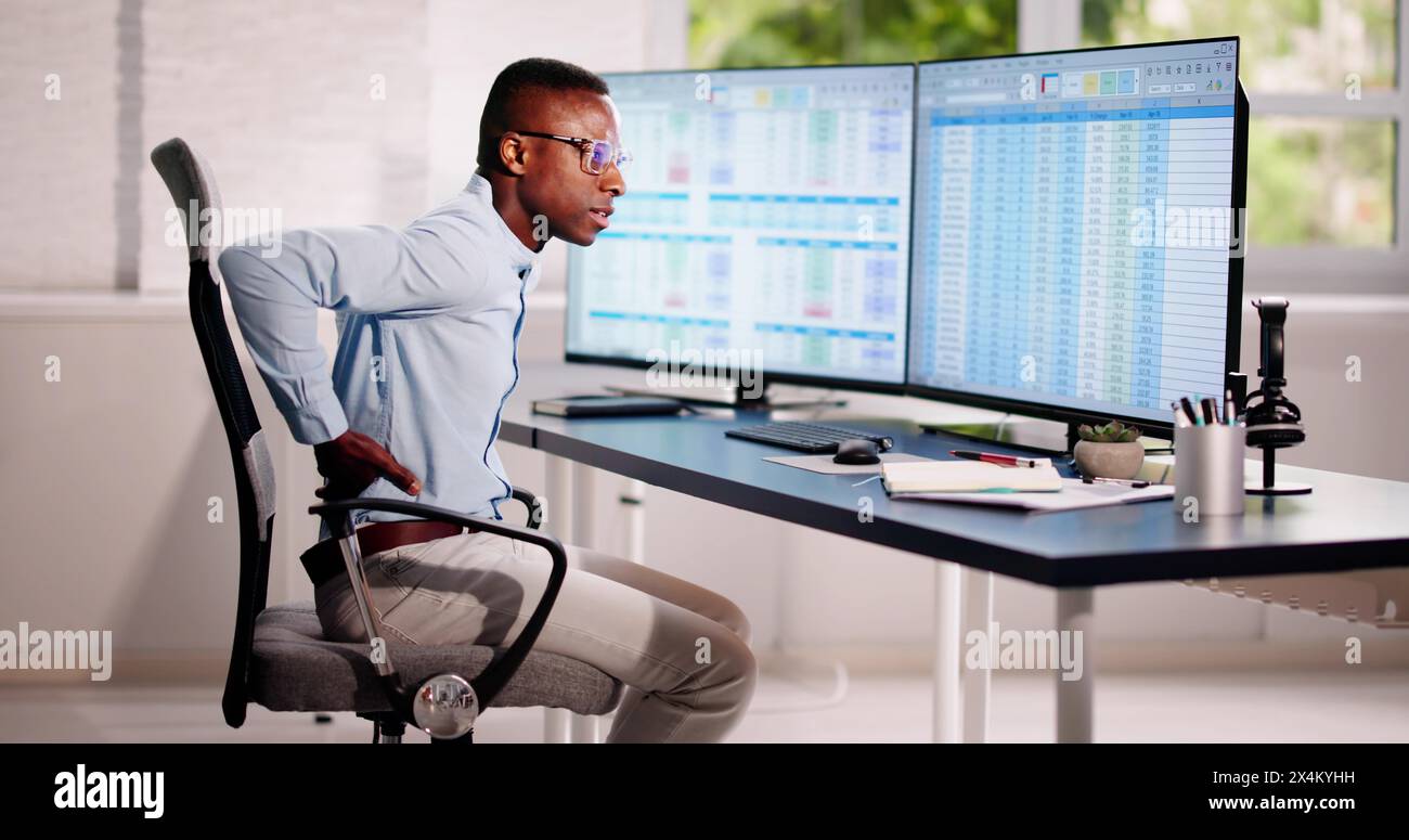 Back Pain Bad Posture Man Sitting In Office Stock Photo - Alamy