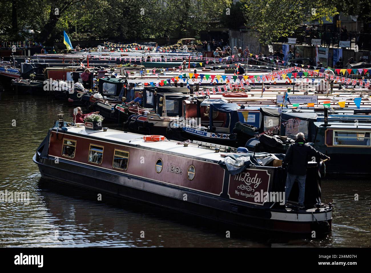 London, UK. 04th May, 2024. Narrowboats covered in bunting line the ...