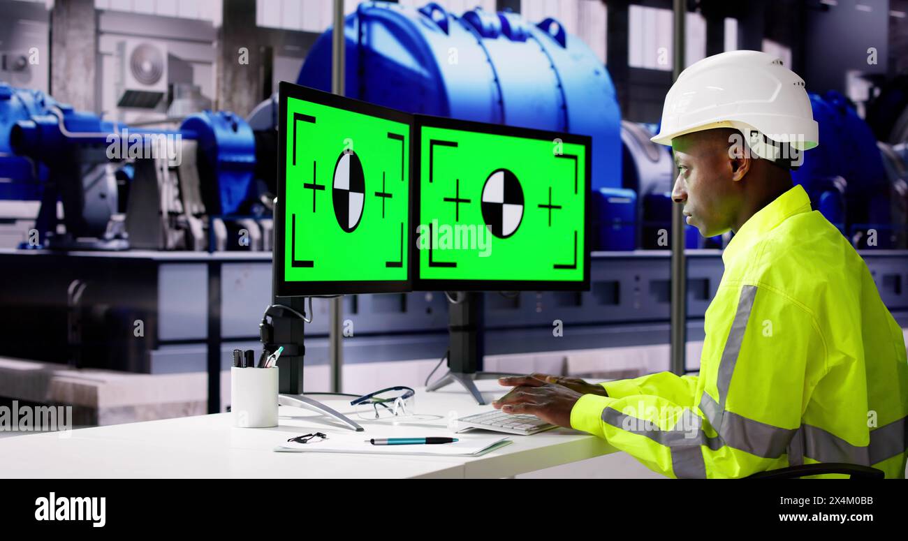 Engineer Using PC Monitor With Green Screen At Power Plant Stock Photo ...