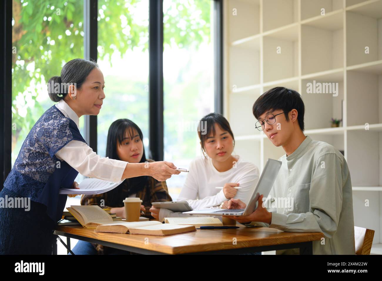 Mature professor explaining something hi-res stock photography and ...