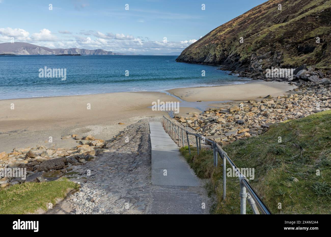 Flat walkway down to a sandy beach and the view out into Keem Bay Stock ...