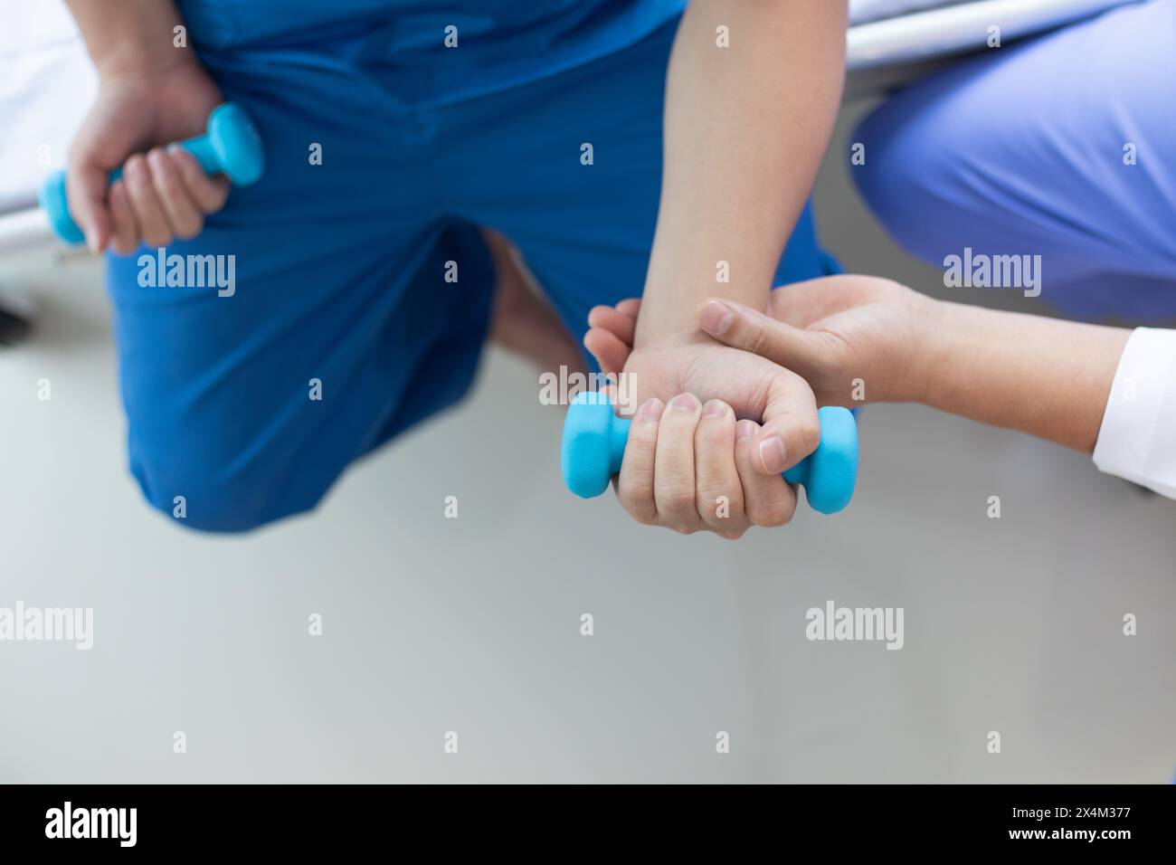 doctor is checking for muscle injuries and using dumbbells test injury ...