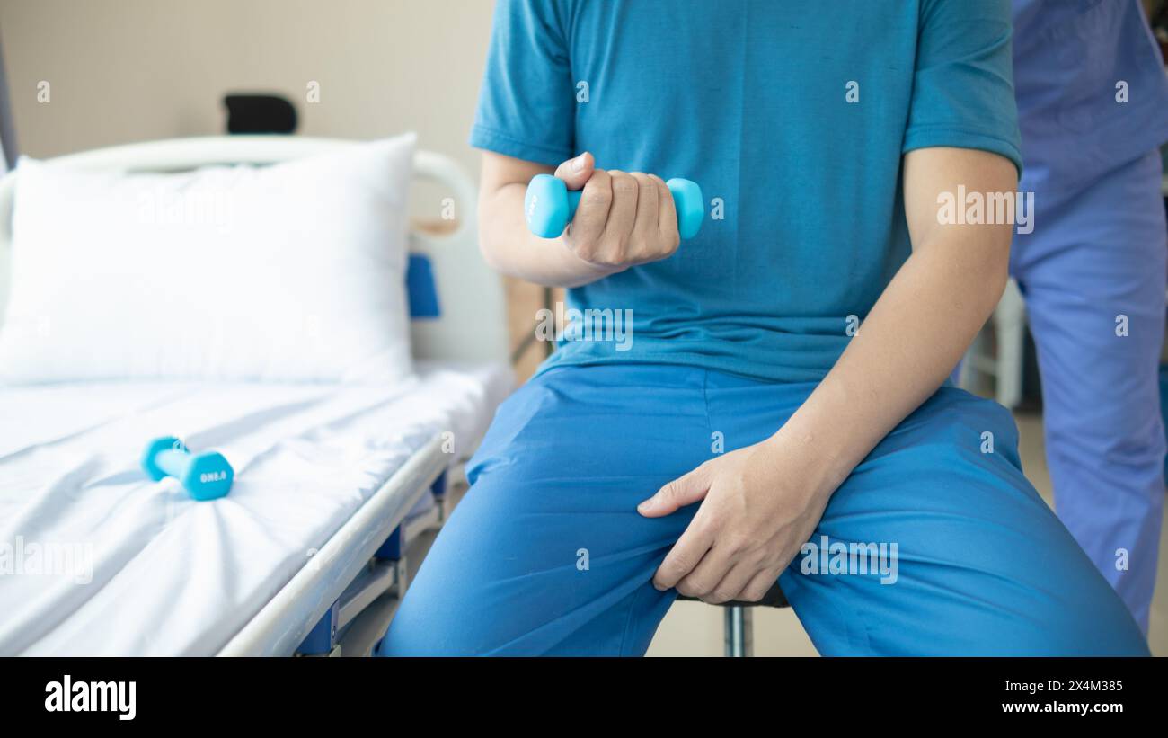 doctor is checking for muscle injuries and using dumbbells test injury ...