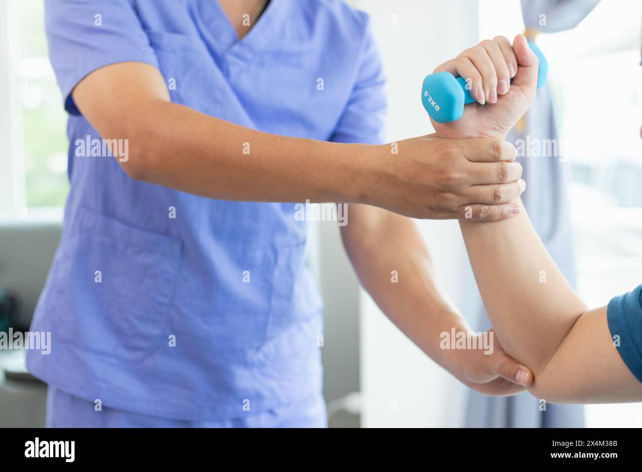 doctor is checking for muscle injuries and using dumbbells test injury ...