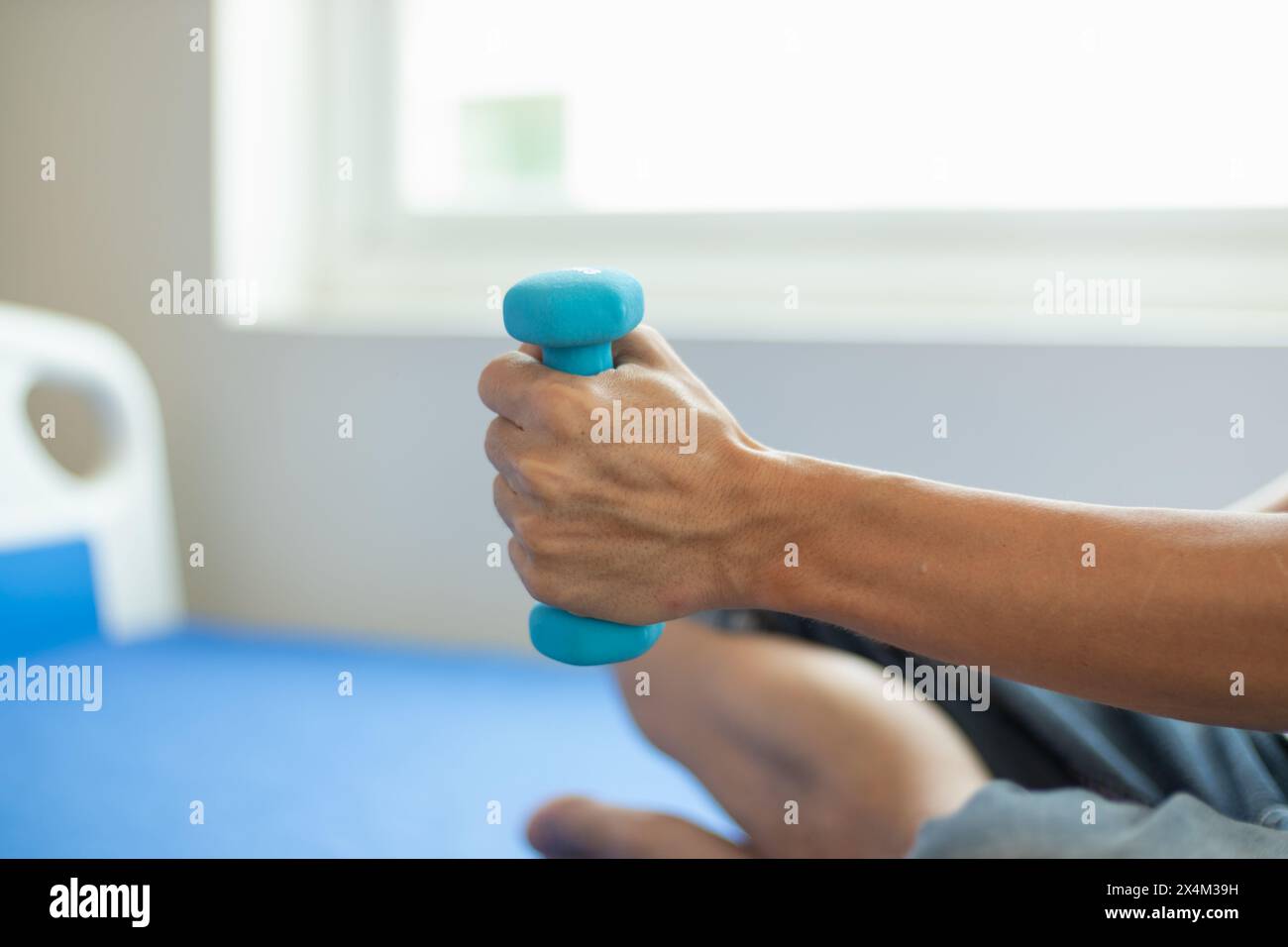 doctor is checking for muscle injuries and using dumbbells test injury ...