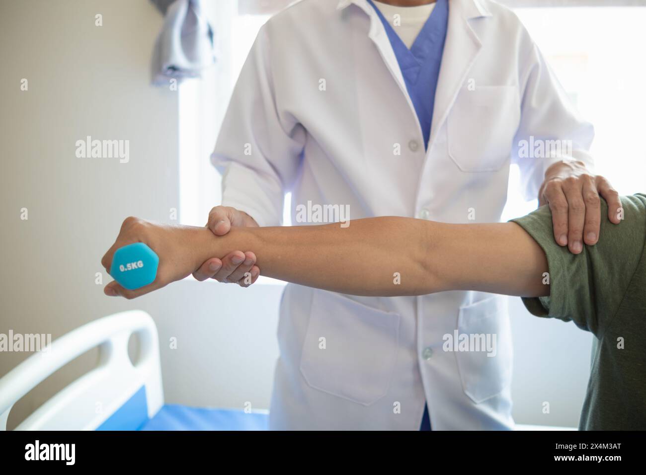 doctor is checking for muscle injuries and using dumbbells test injury ...