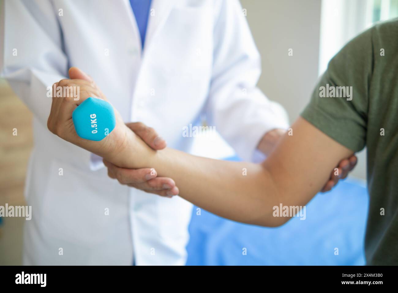 doctor is checking for muscle injuries and using dumbbells test injury ...