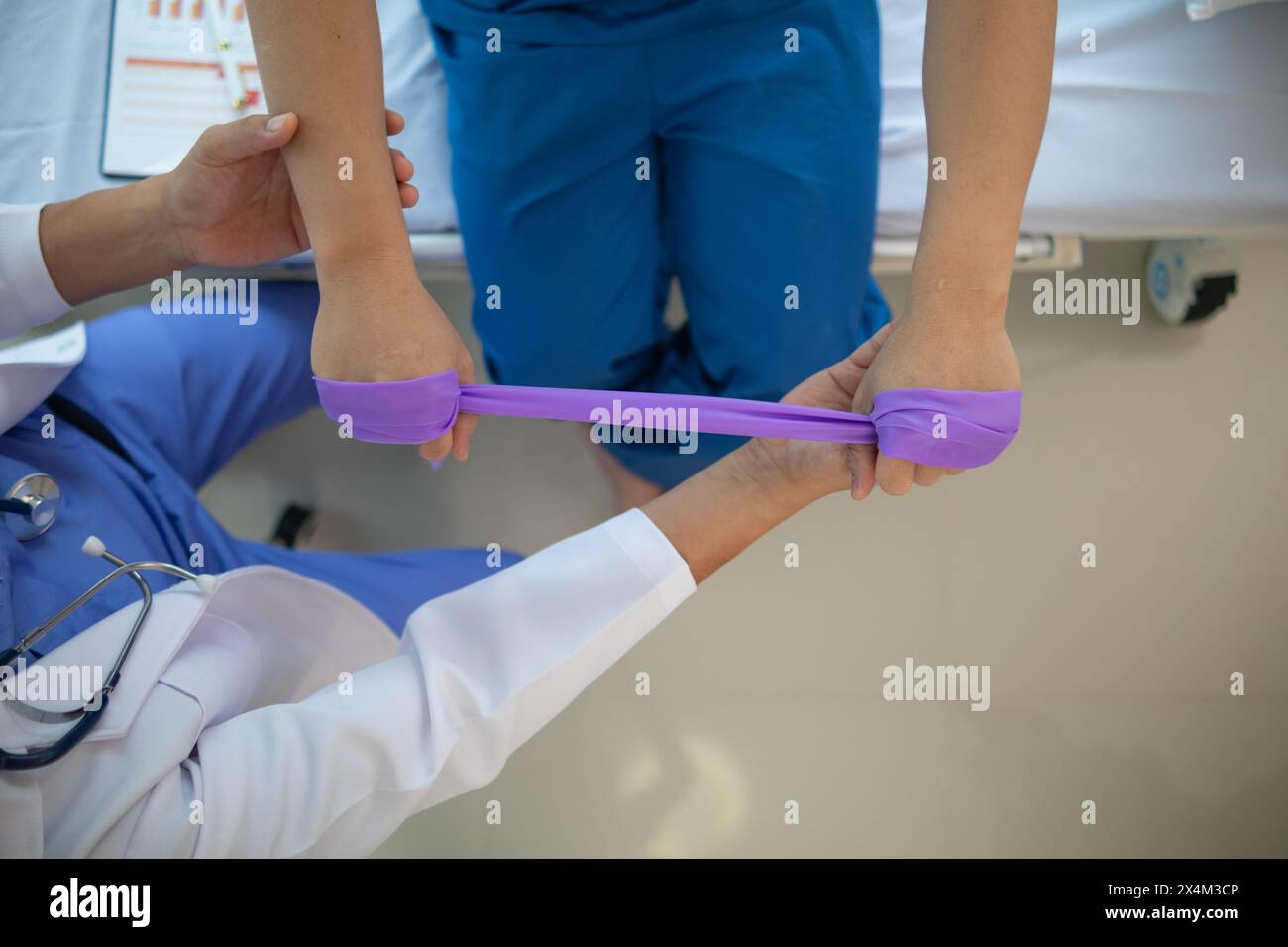 doctor is examining muscle injury and using elastic bands test injury ...