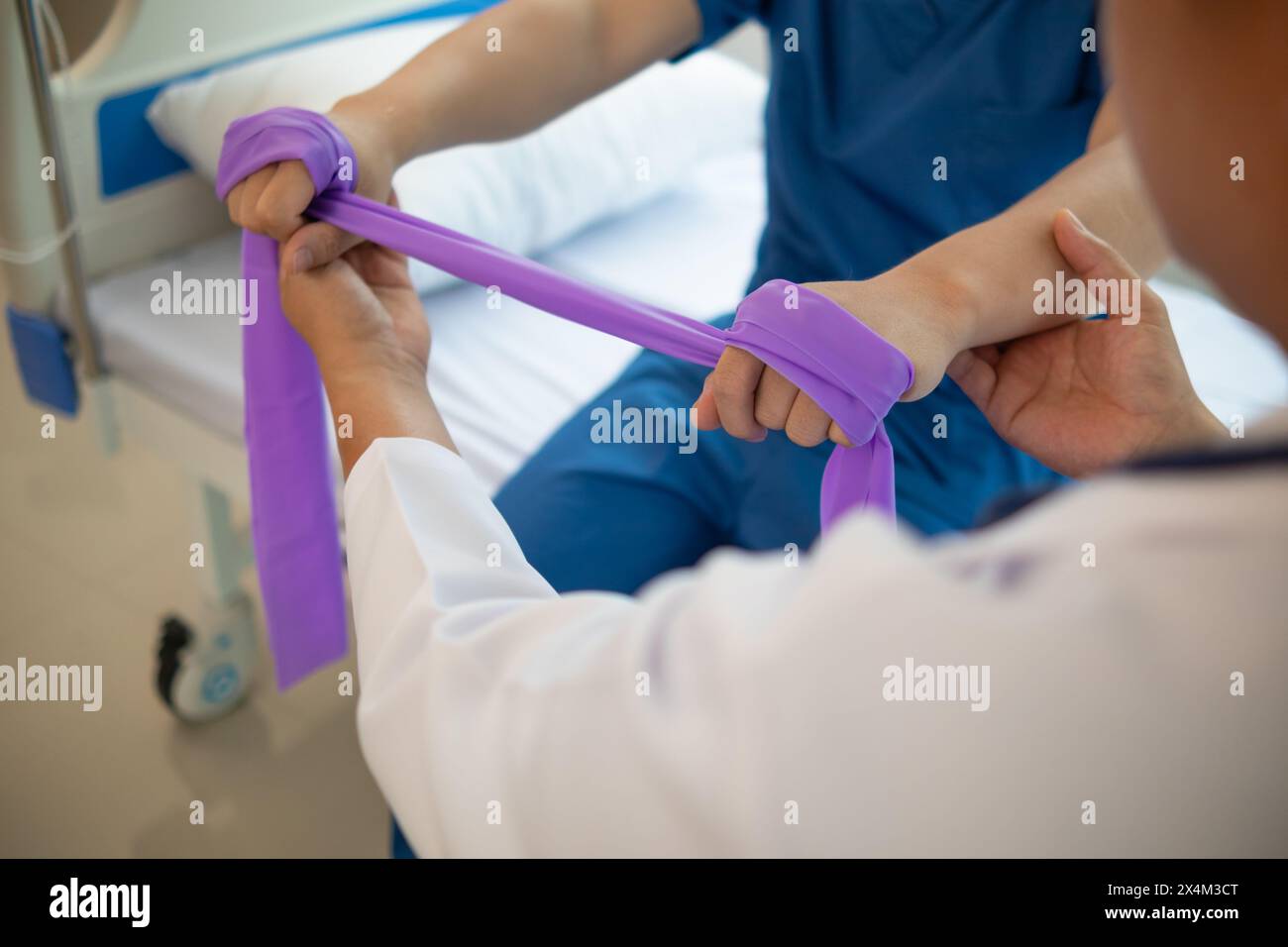 doctor is examining muscle injury and using elastic bands test injury ...