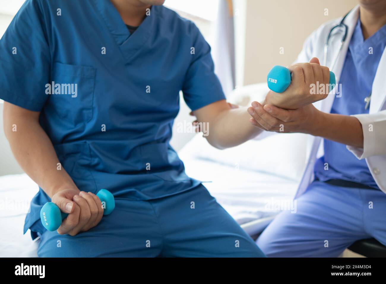 doctor is checking for muscle injuries and using dumbbells test injury ...