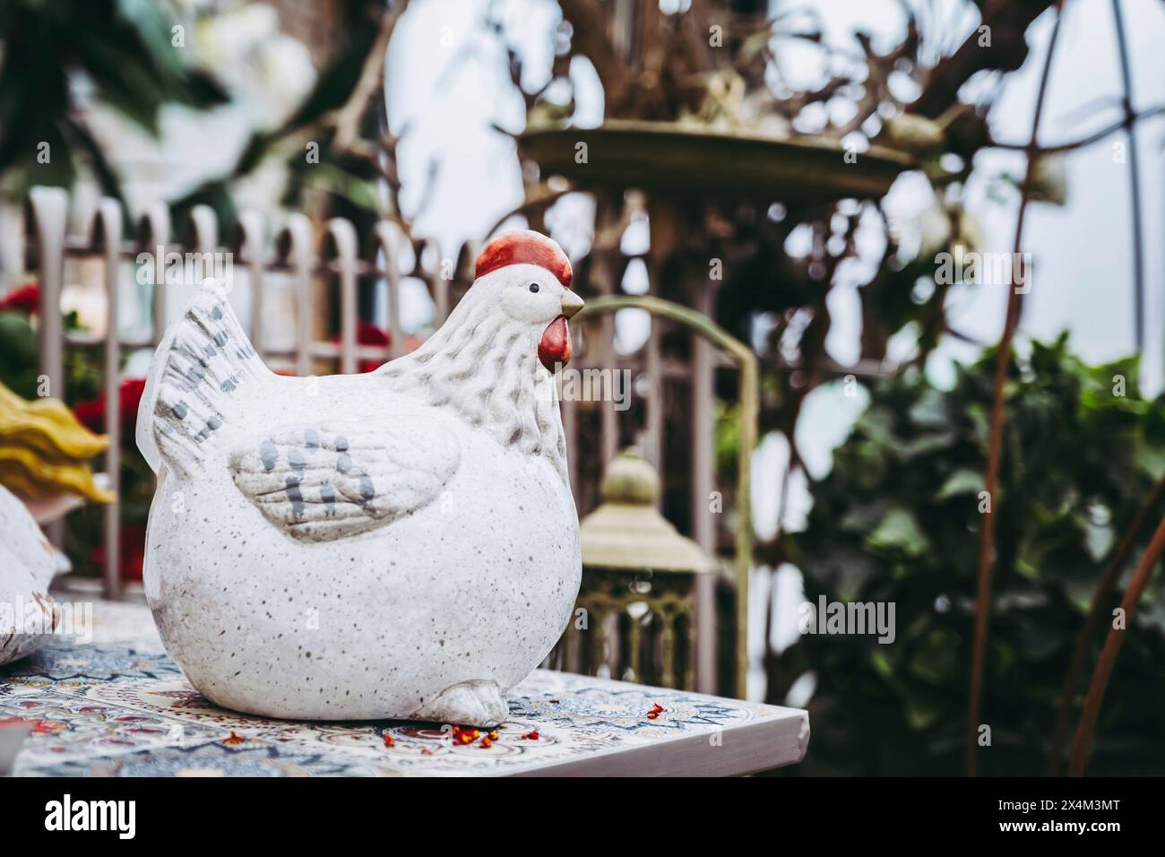 Pretty ceramic hen in country style interior decoration Stock Photo - Alamy