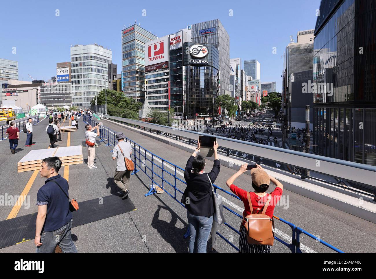 Participants walk on the Tokyo Expressway during an event "GINZA SKY ...