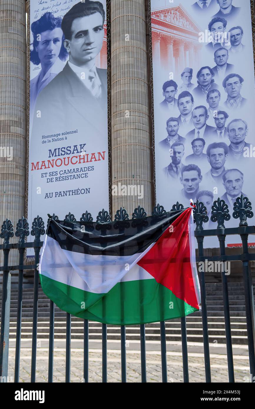 A Palestinian flag hangs on the fence of the Pantheon near a banner ...