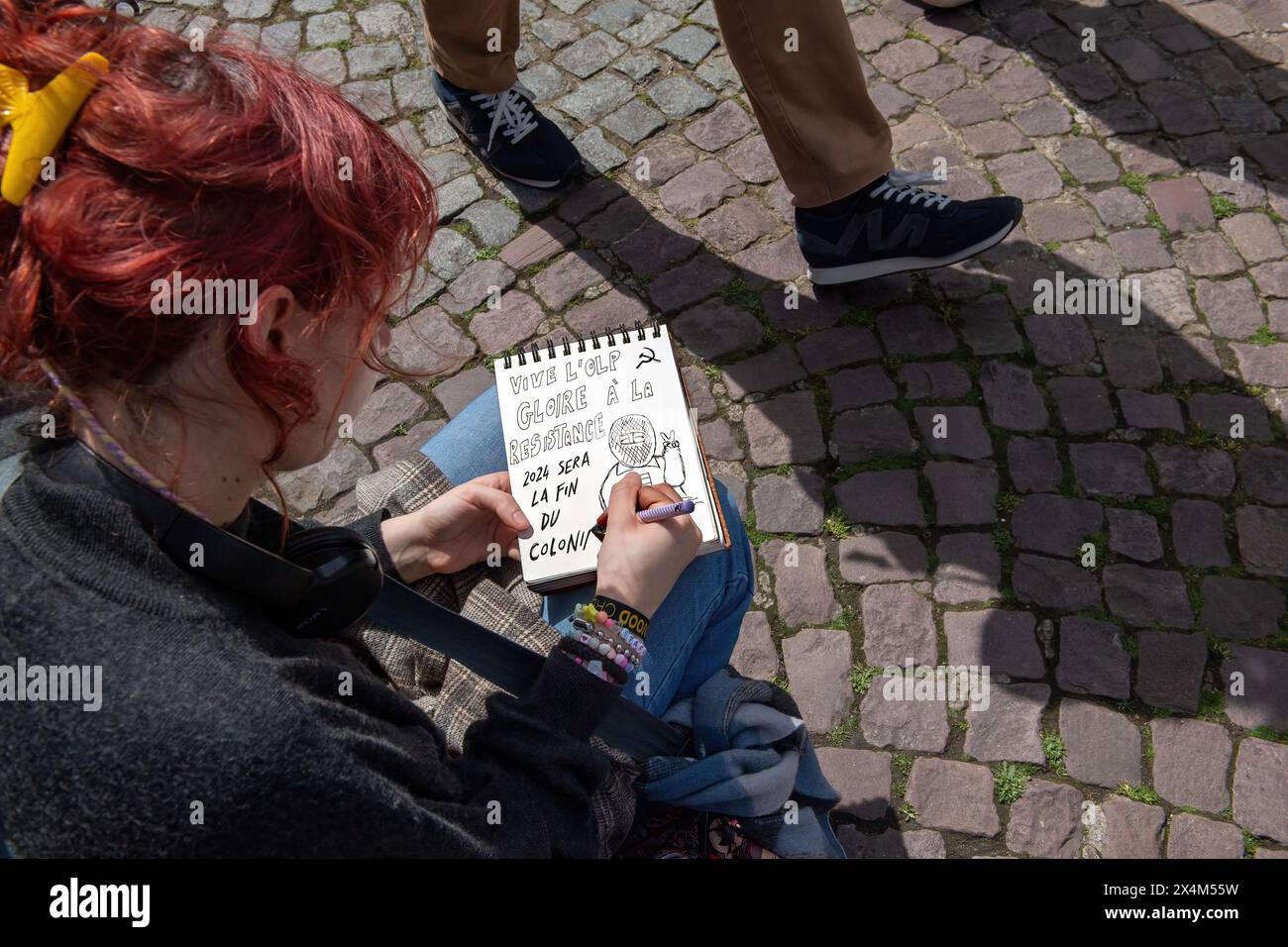 A student works on a design for a protest banner during a Pro-Palestine ...