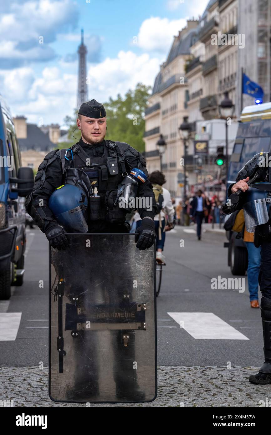 A French riot policeman stand with his shield near a Pro-Palestine ...