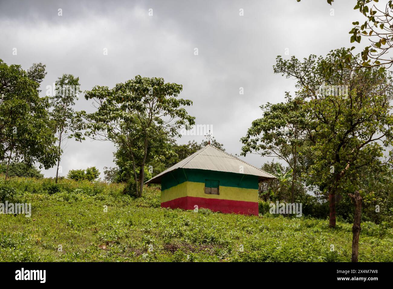 A charming Orthodox Ethiopian church sits atop a tranquil hill,vividly ...