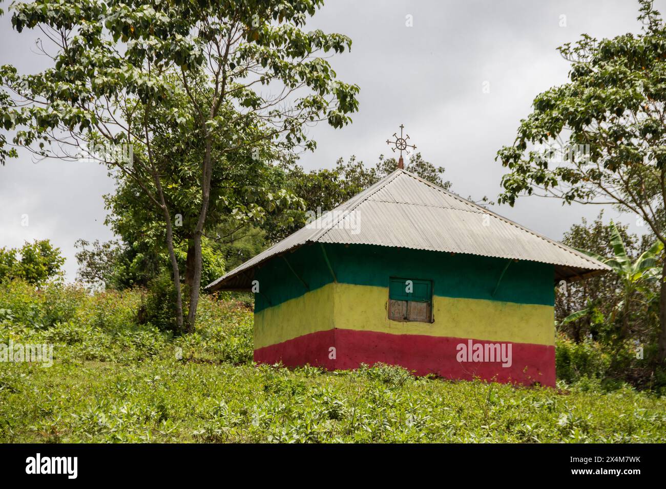 A charming Orthodox Ethiopian church sits atop a tranquil hill,vividly ...
