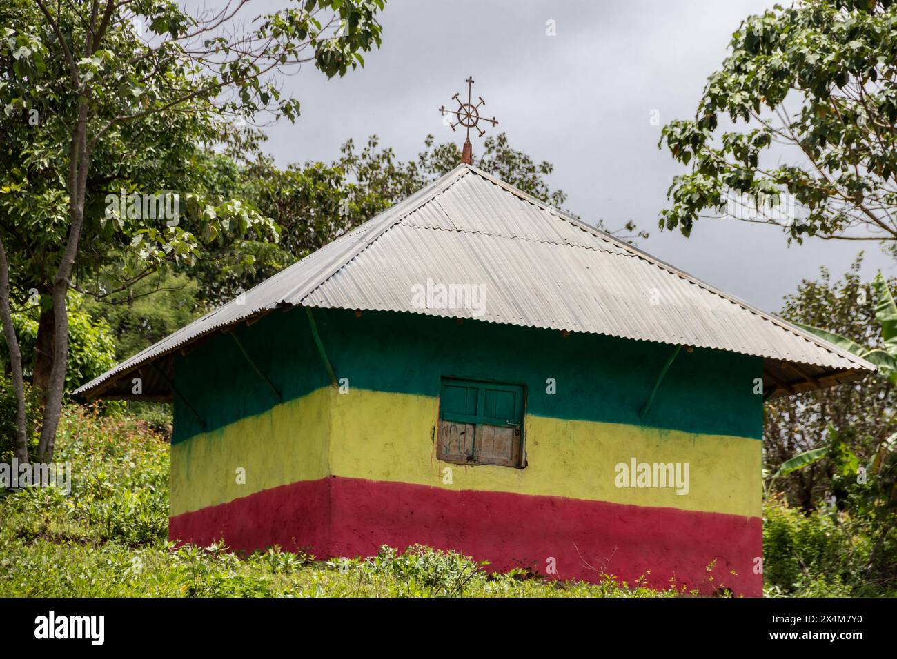 A charming Orthodox Ethiopian church sits atop a tranquil hill,vividly ...