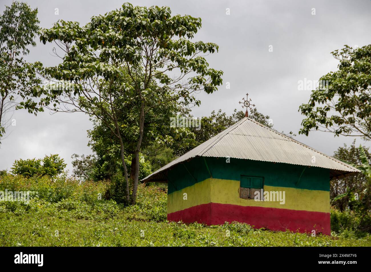 A charming Orthodox Ethiopian church sits atop a tranquil hill,vividly ...
