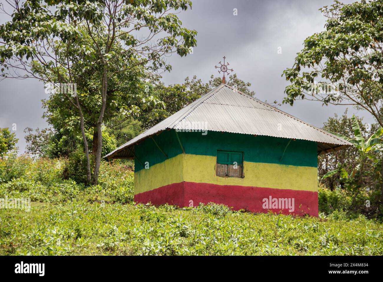 A charming Orthodox Ethiopian church sits atop a tranquil hill,vividly ...