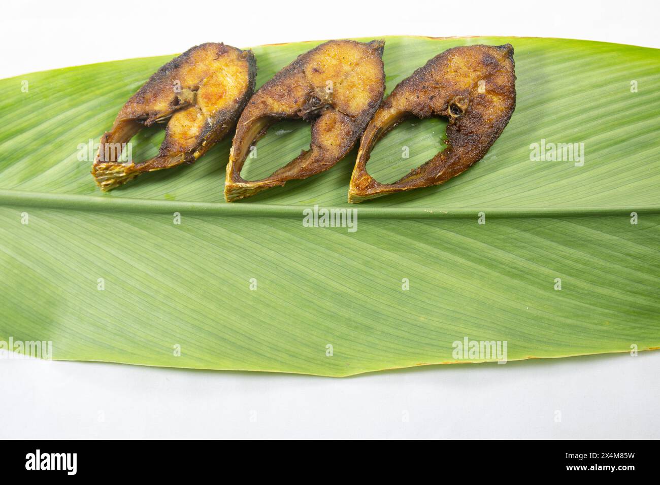 Fried Ilsha on Turmeric leaf. Hilsa fry is popular in pohela boishakh ...