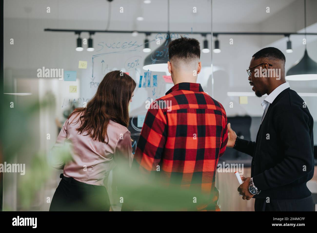 Multiracial team collaborates on creative project in modern office with ...