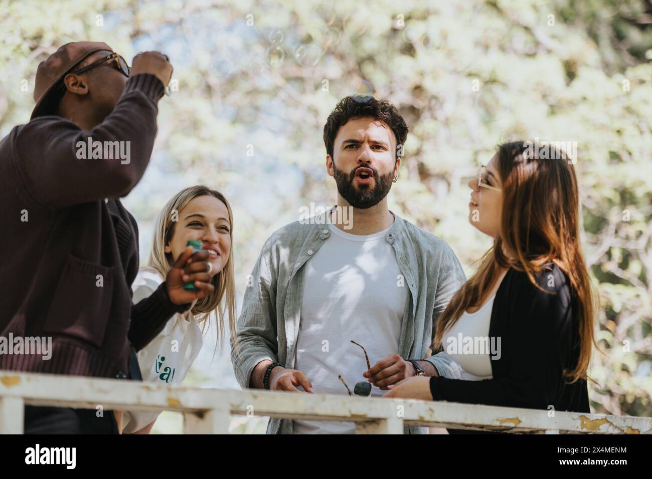 Joyful friends blowing bubbles hi-res stock photography and images - Alamy
