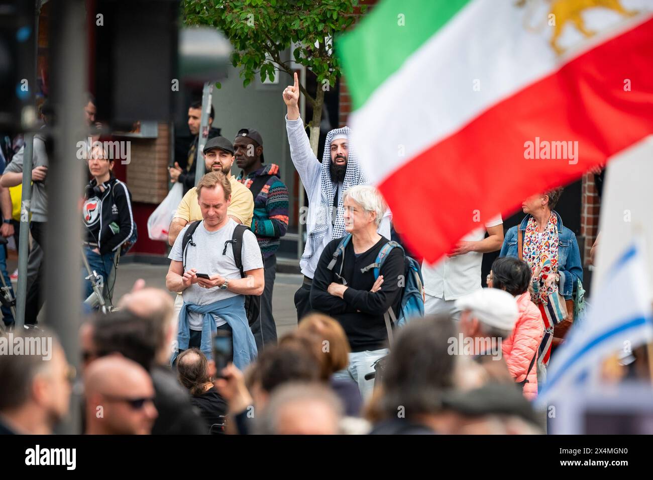 Hamburg, Germany. 04th May, 2024. A man raises his finger (Islamic ...