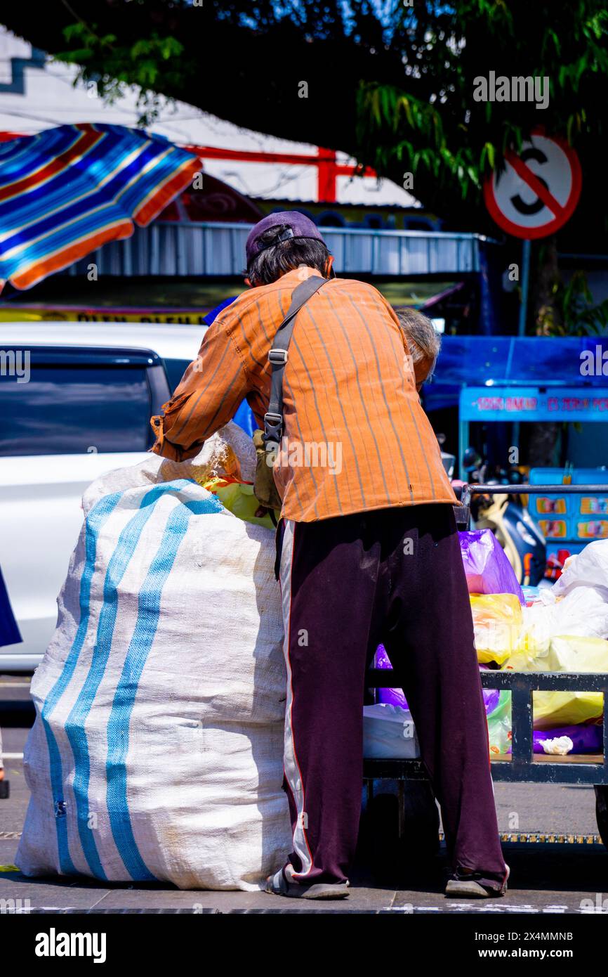 Old people in shabby clothes looking for plastic bottles to sell Stock ...